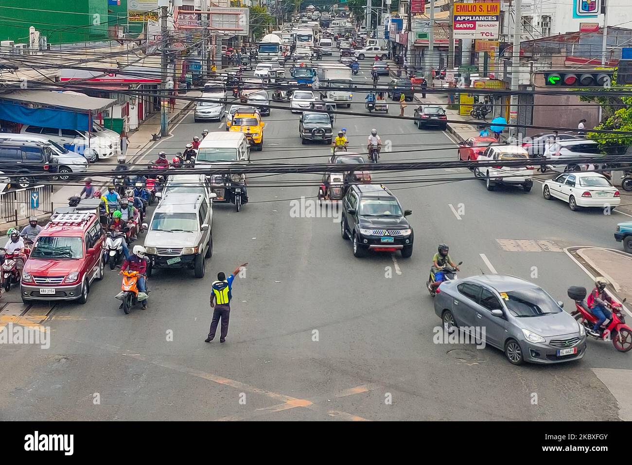 Traffic enforcers are directing the heavy traffic near public market ...