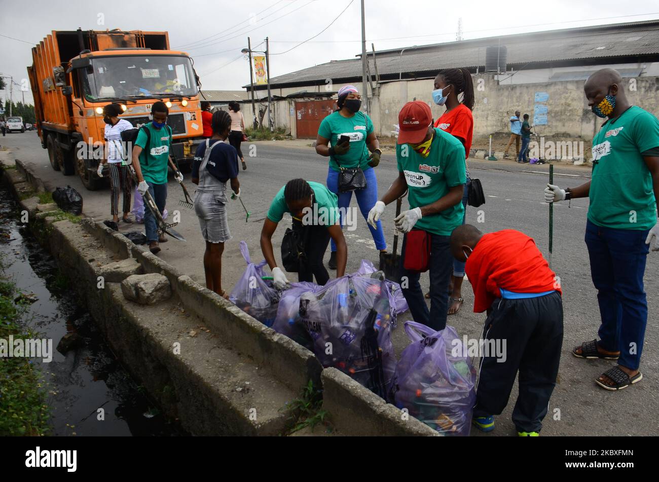 Groups of volunteers picking waste on the road sides and drainages in ...
