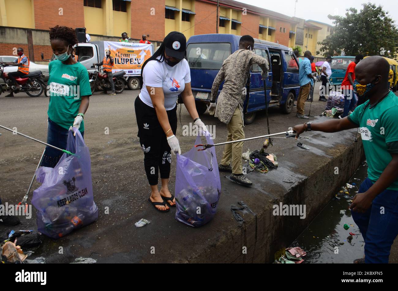 Groups of volunteers picking waste on the road sides and drainages in ...