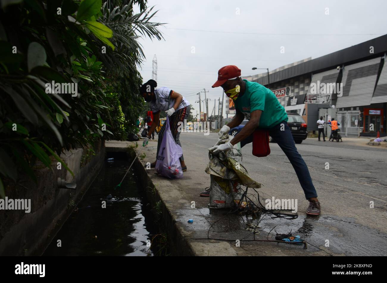 Groups of volunteers picking waste on the road sides and drainages in ...