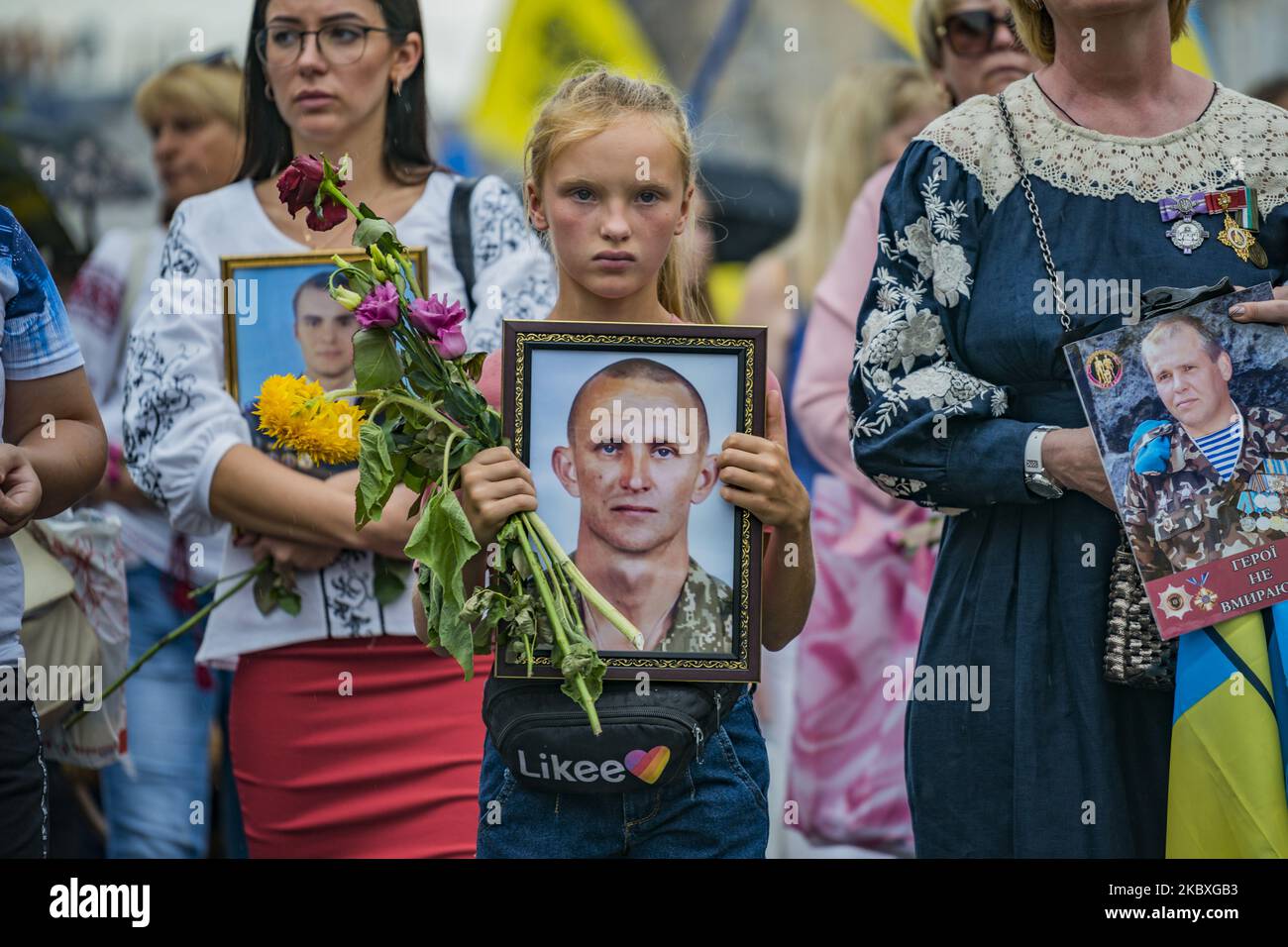 A girl holds a photo of his father killed in Donbass war during the ...