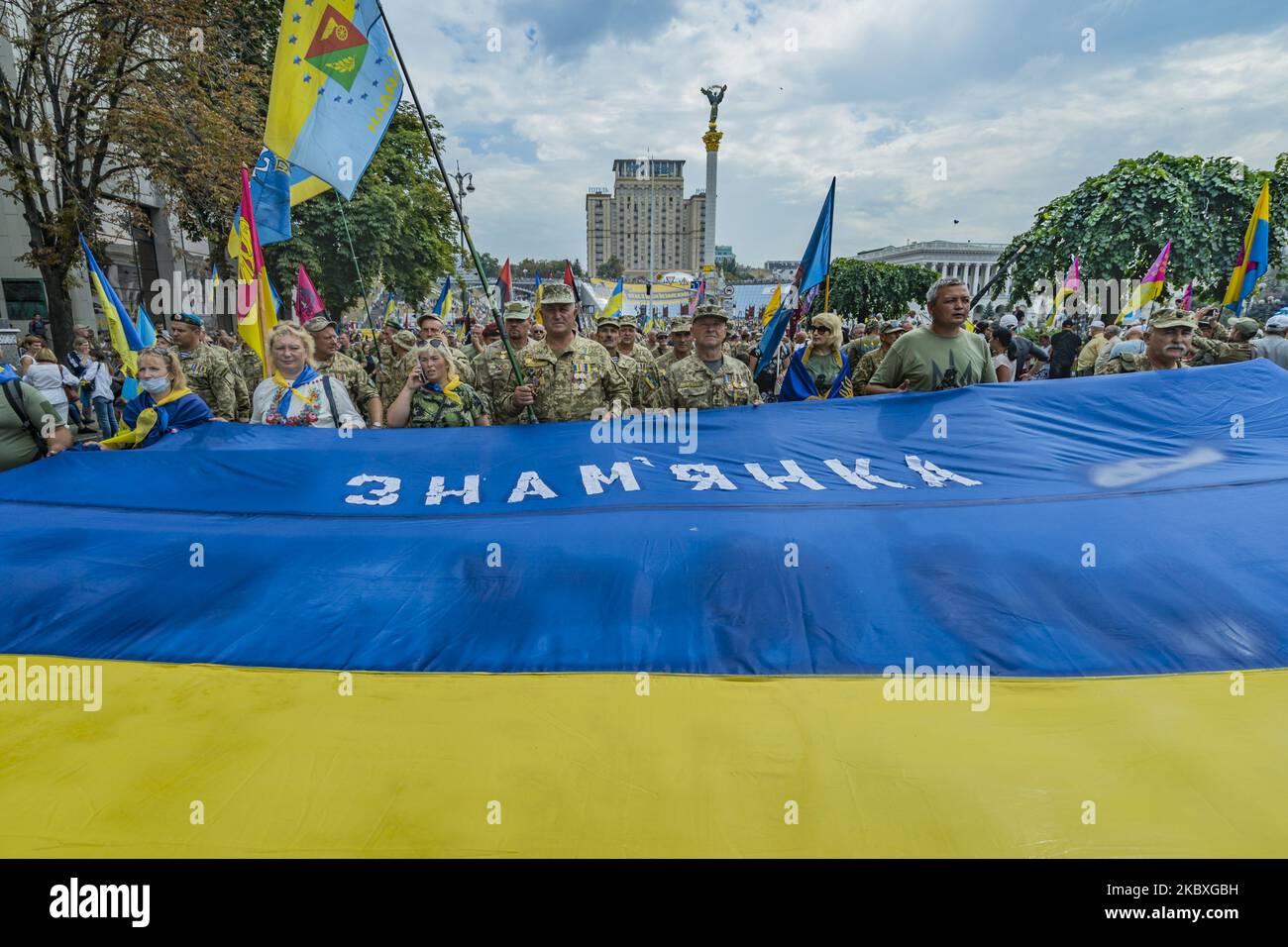 Veterans marching with a huge ukrainian flag during the celebrations of ...
