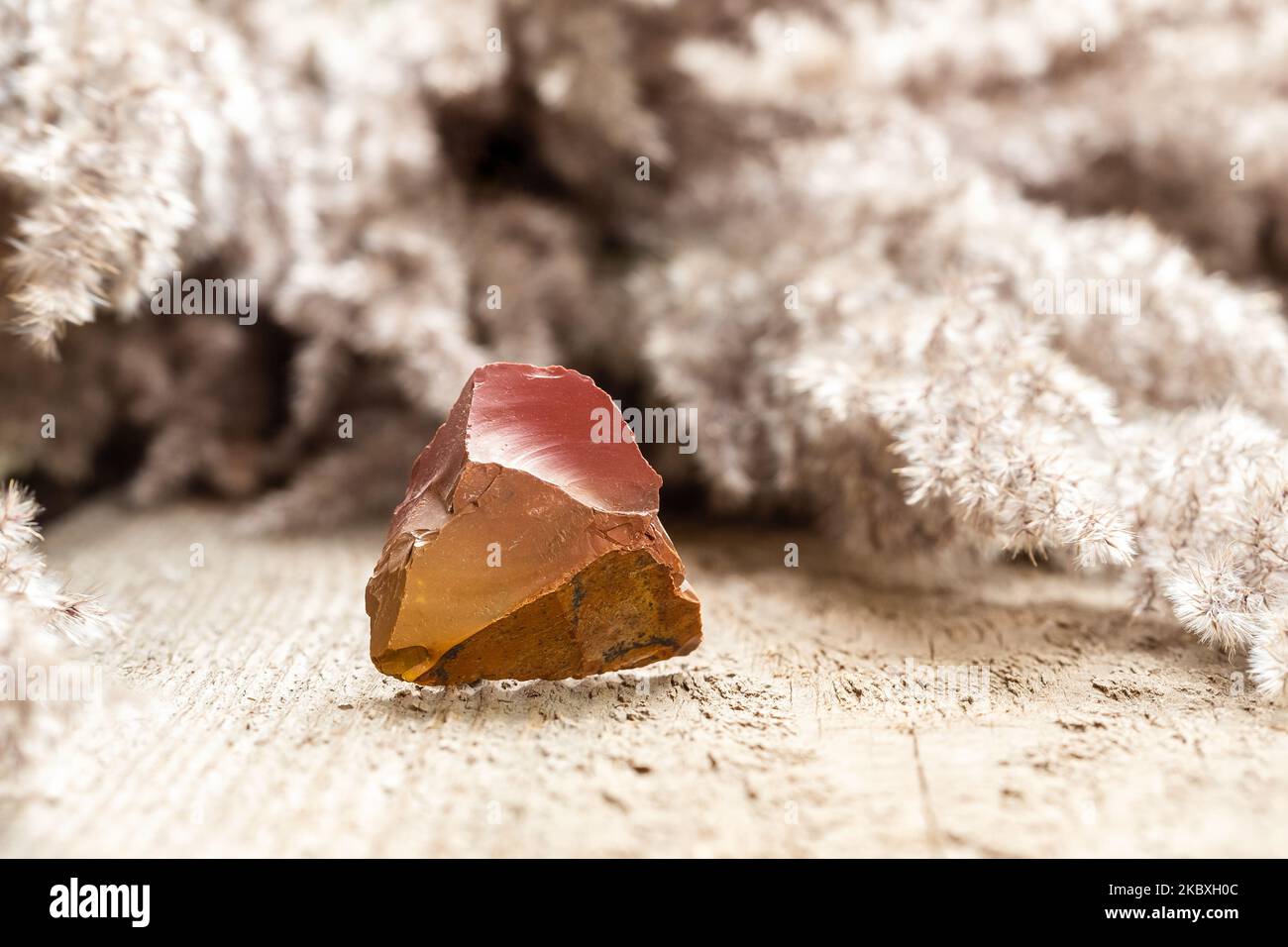 Beautiful Sample of Red and Orange Flint Rock over Wooden Background ...