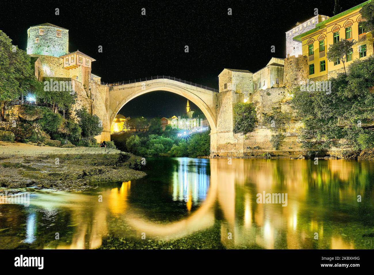 An old bridge under a clear starry night sky in Mostar, Bosnia and ...