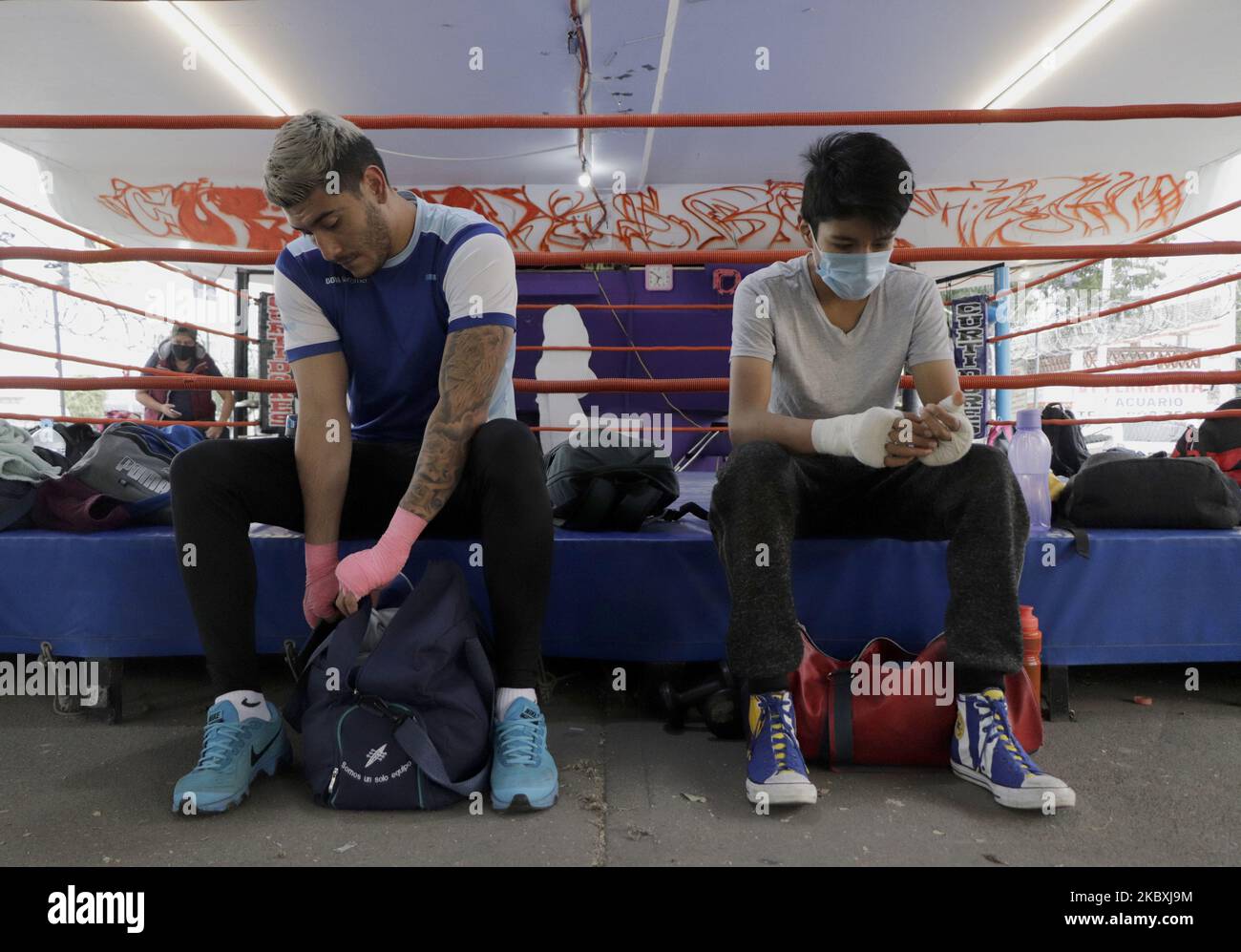 Young people putting bandages on their hands before starting boxing ...
