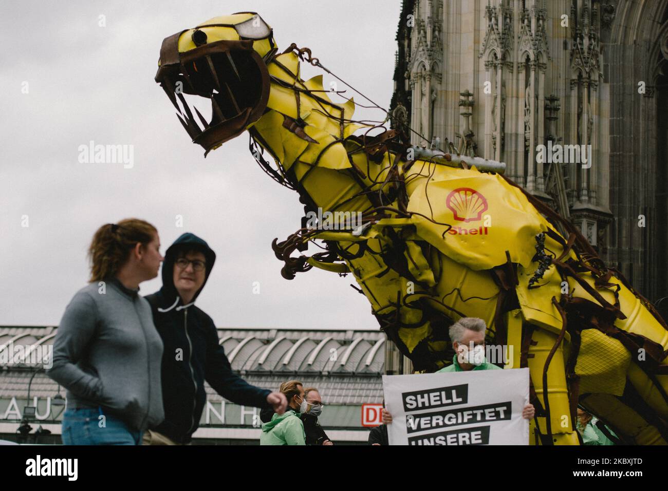 Green peace activists protest in front of Dom cathedral with Dinosauer ...