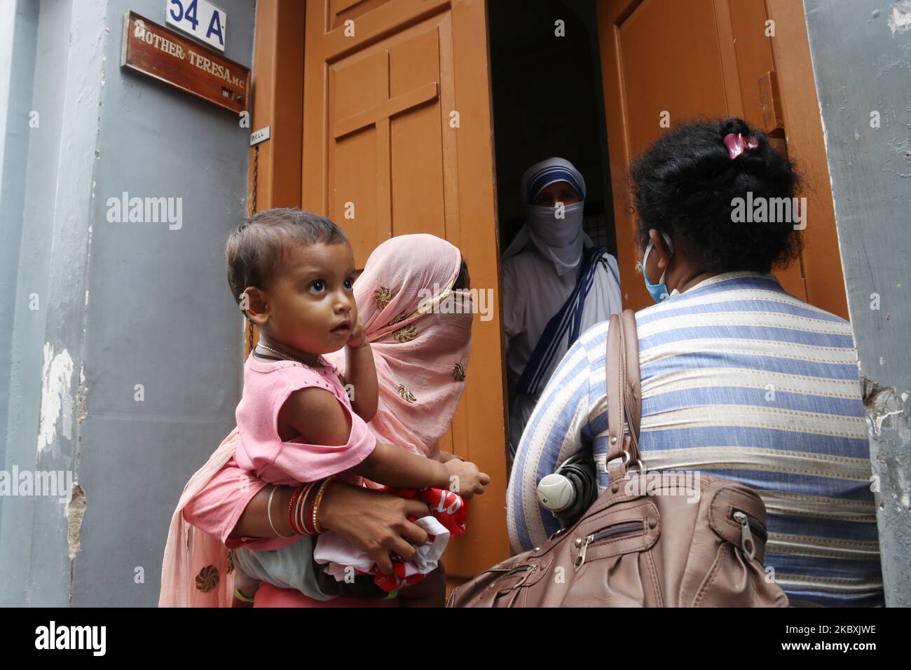Underprivileged people wait outside the Mother House and collect Foods ...