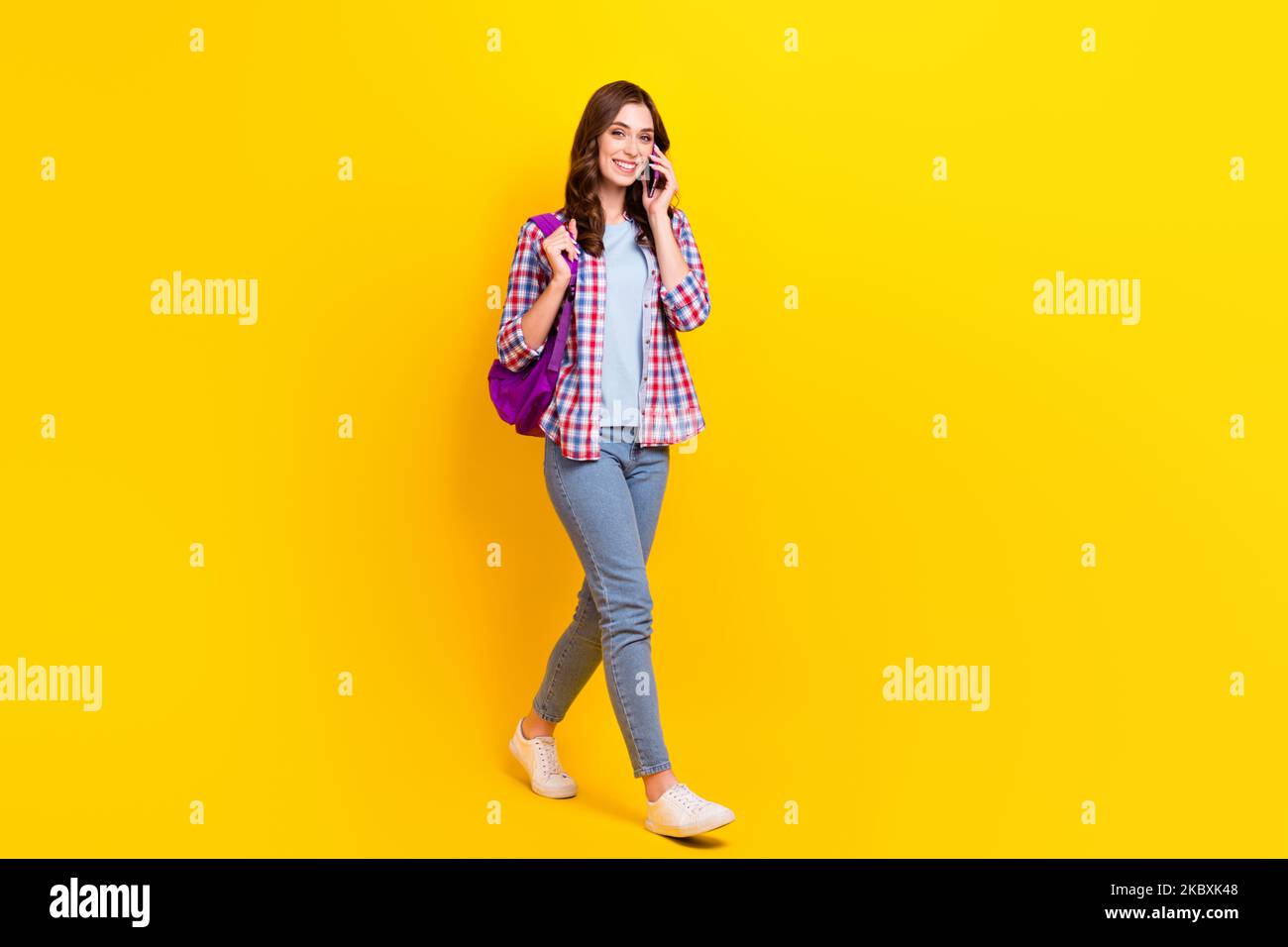 Full body size of confident student hold smartphone talking friend ...