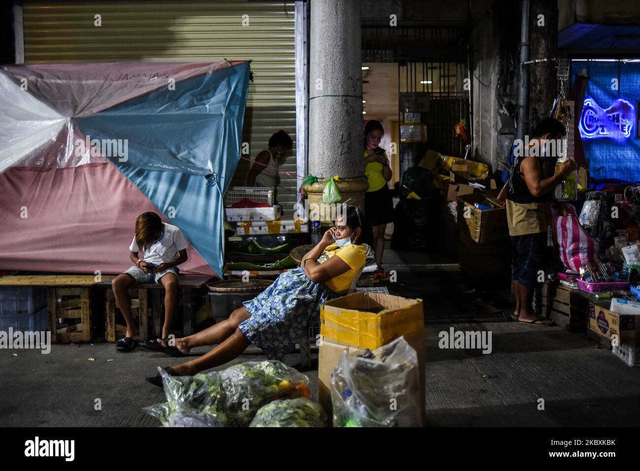 Vendors rest during closing hours of stores in Manila, Philippines on ...