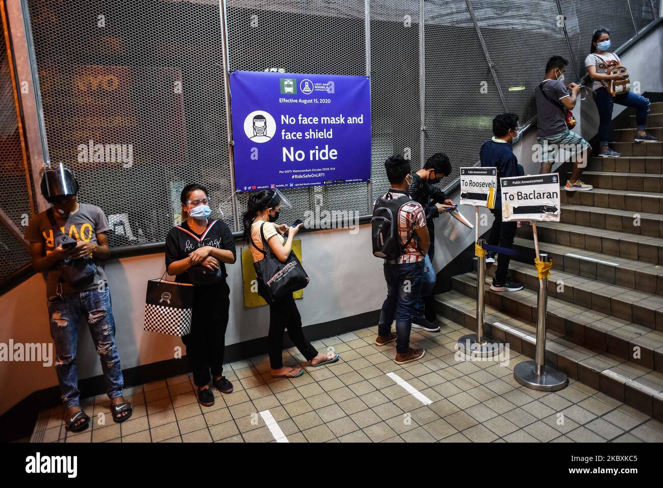 People queue at a train station in Manila, Philippines on August 26 ...