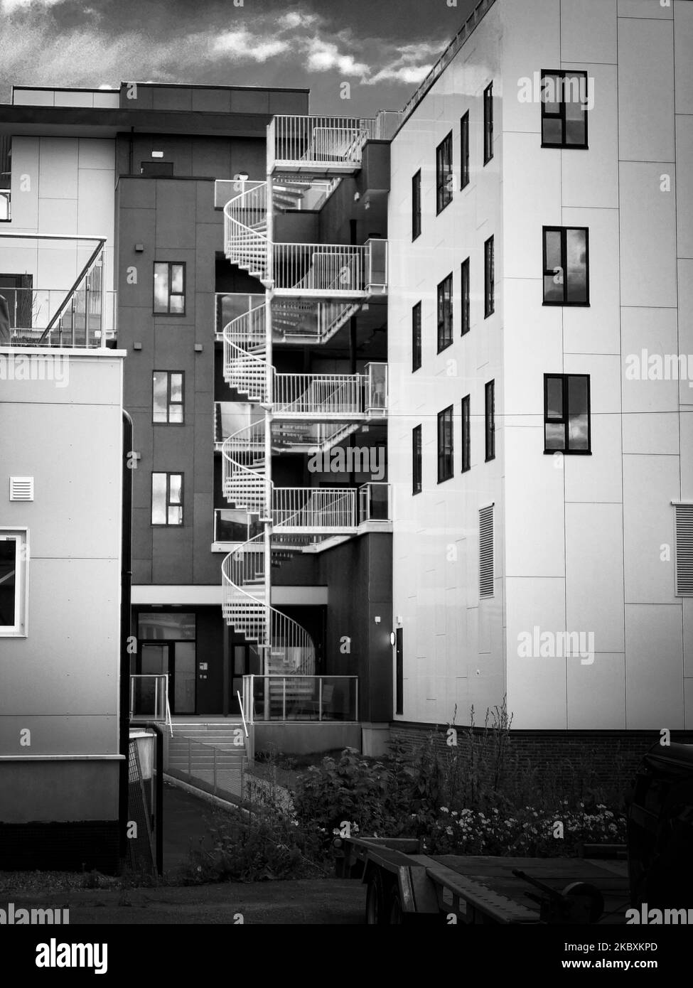 A vertical and monochrome shot of the modern building Stock Photo - Alamy
