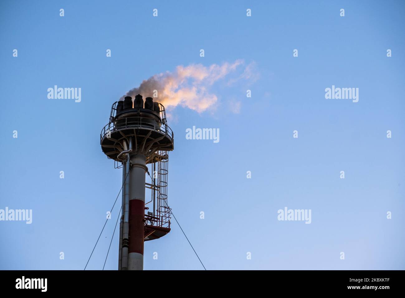 A firer on the top of the tower of the petrochemical industry in a ...
