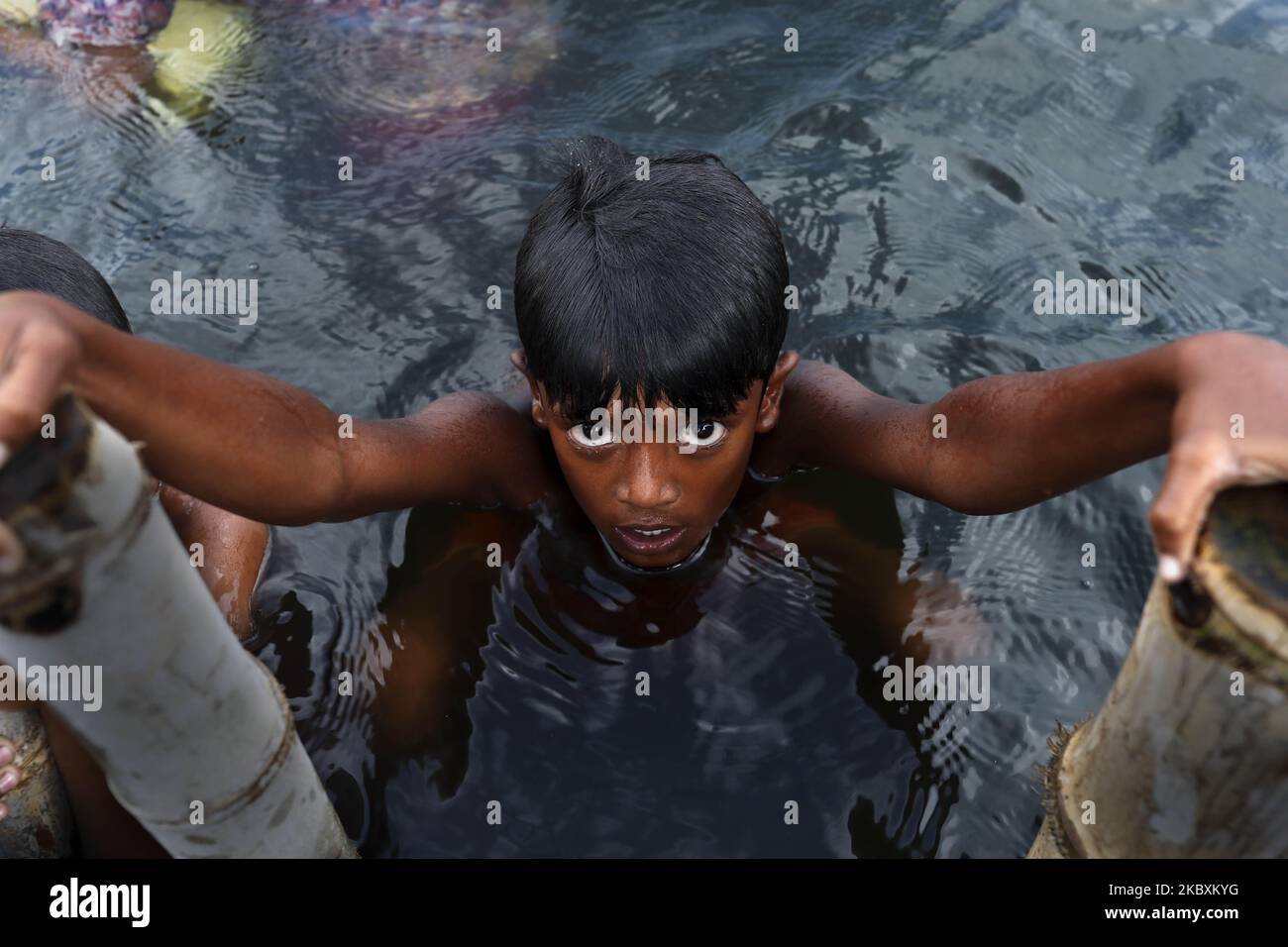 A ten years boy playing in a reservoir at Dhaka Bangladesh on August 27, 2020. (Photo by Kazi ...