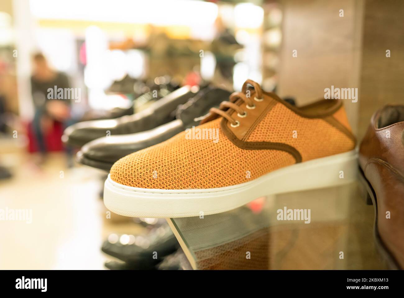 Shelves with different footwear at shoes store - new fashion collection ...