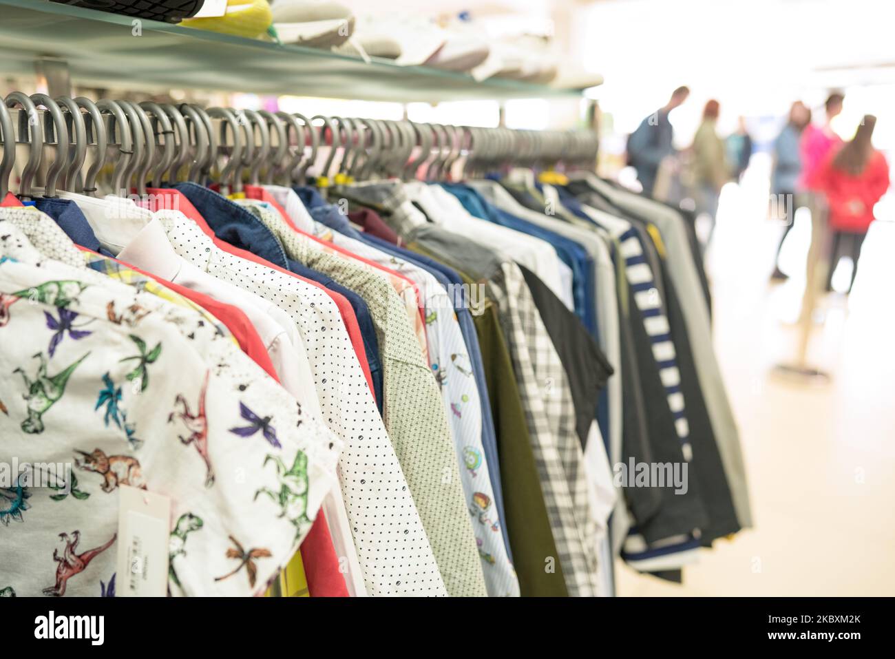 Clothes stall against blurred store background with copy space. Clothes ...