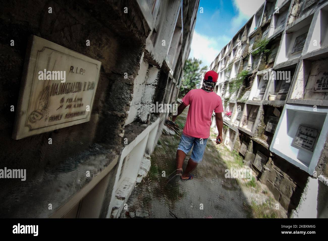 Erwin, 28, working inside the public cemetery in Antipolo City ...