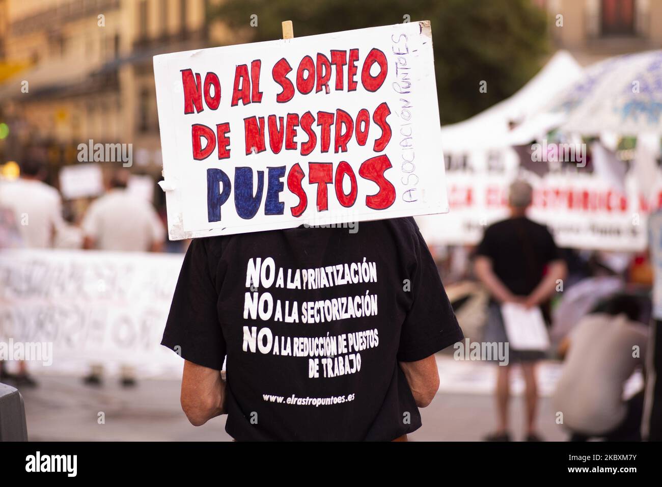 Traders from El Rastro in Madrid hold banners during the demonstration ...