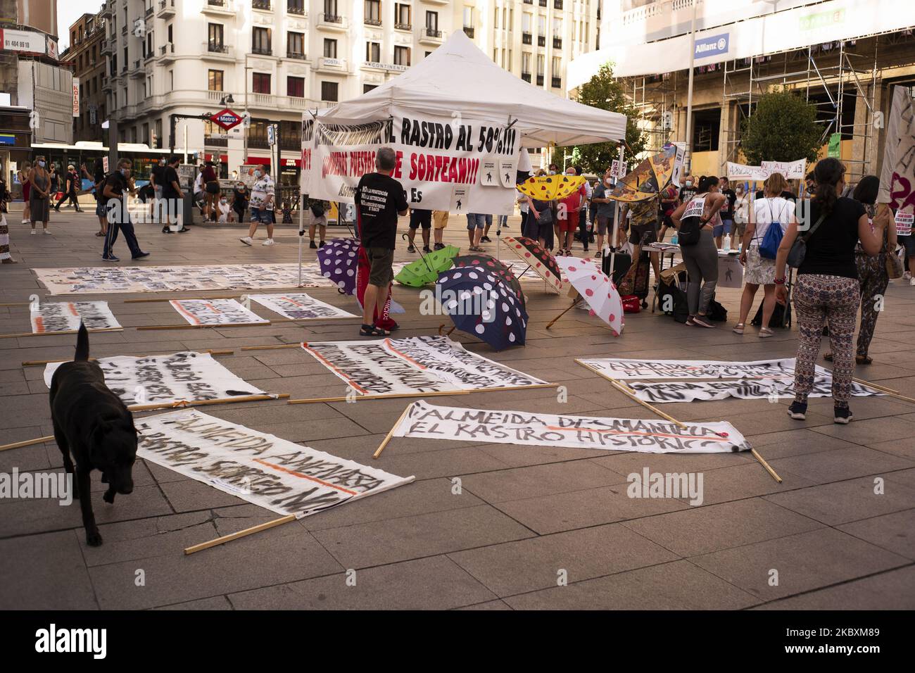 Traders from El Rastro in Madrid hold banners during the demonstration ...