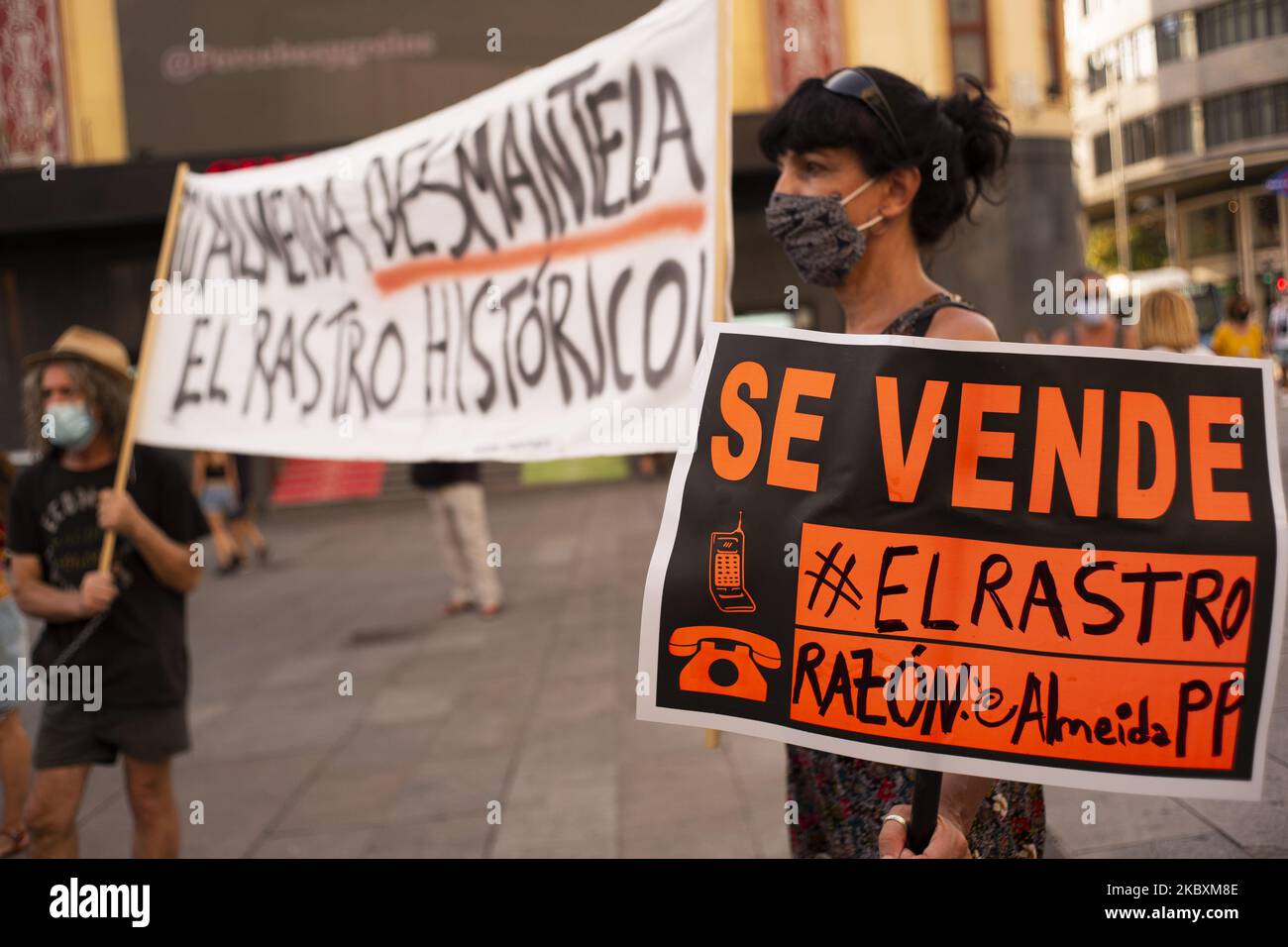 Traders from El Rastro in Madrid hold banners during the demonstration ...