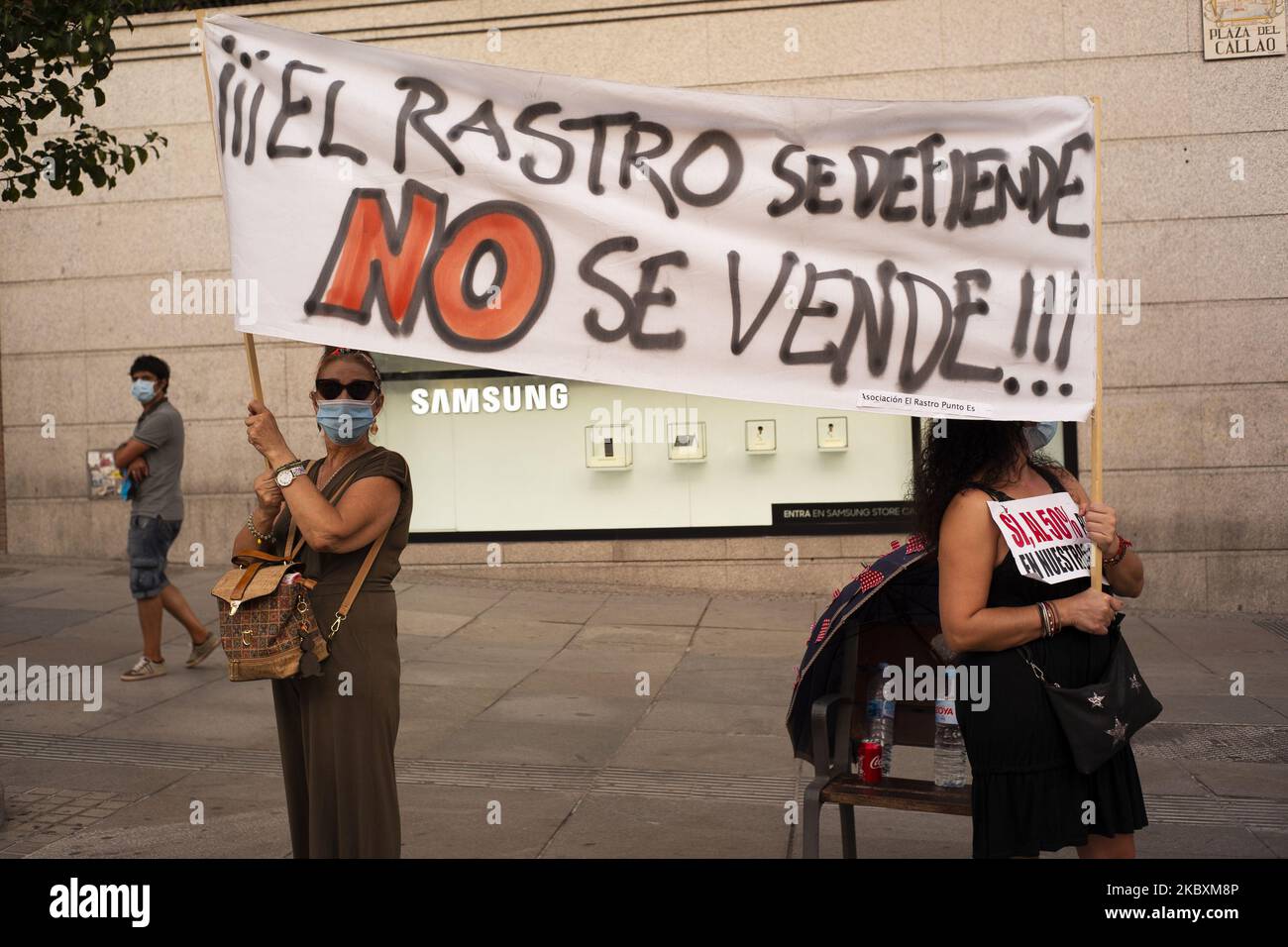 Traders from El Rastro in Madrid hold banners during the demonstration ...