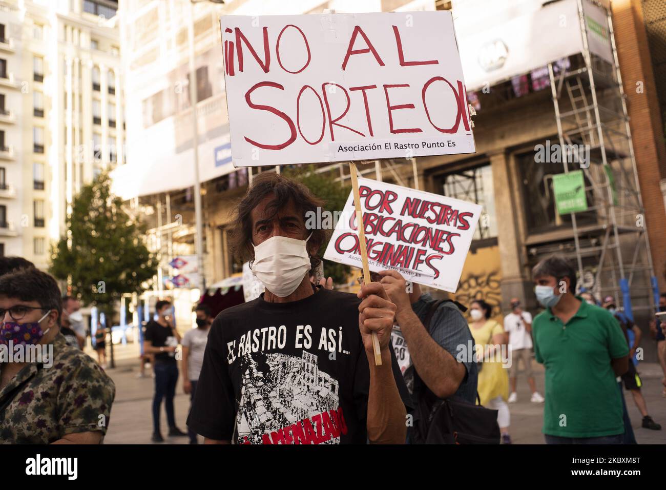 Traders from El Rastro in Madrid hold banners during the demonstration ...