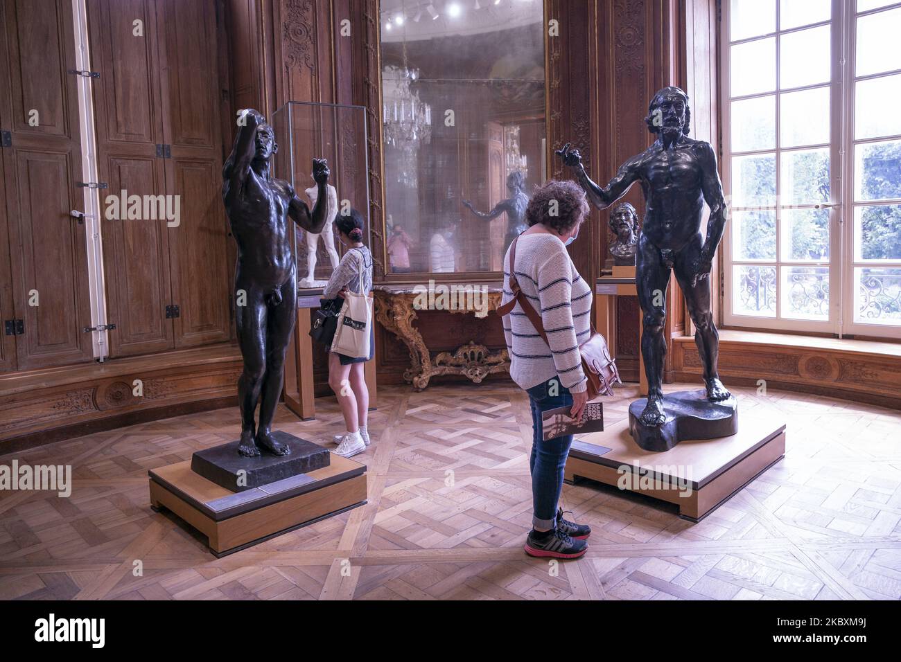 Visitors look the bronze sculptures at the Rodin museum in Paris ...