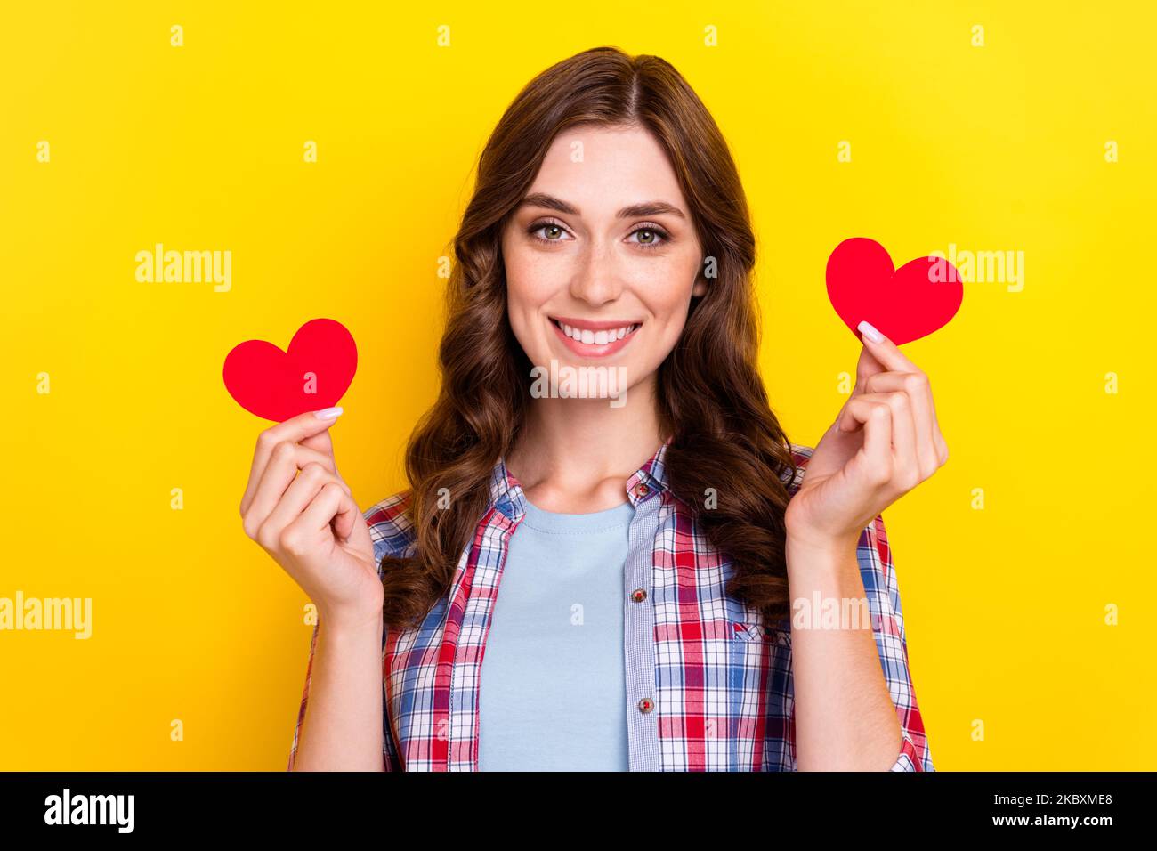 Portrait of charming young lovely woman wear checkered shirt hold paper ...