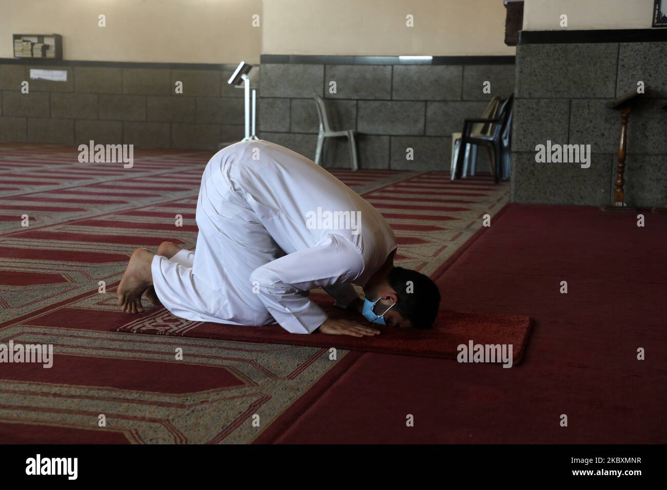 A Palestinian member of the staff prays in an almost empty mosque as ...