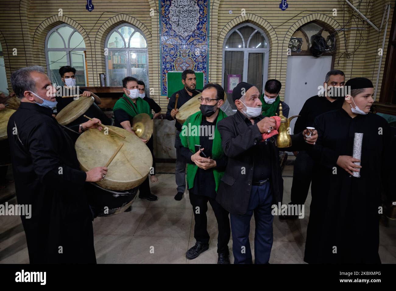 Iraqi immigration men living in Tehran wearing protective face masks ...