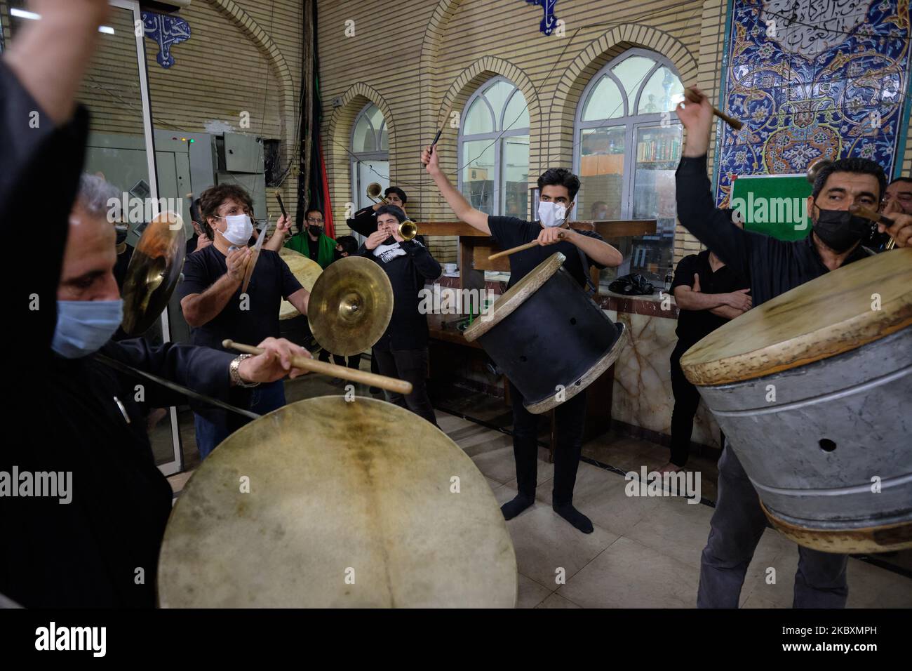 Iraqi immigration men living in Tehran wearing protective face masks ...