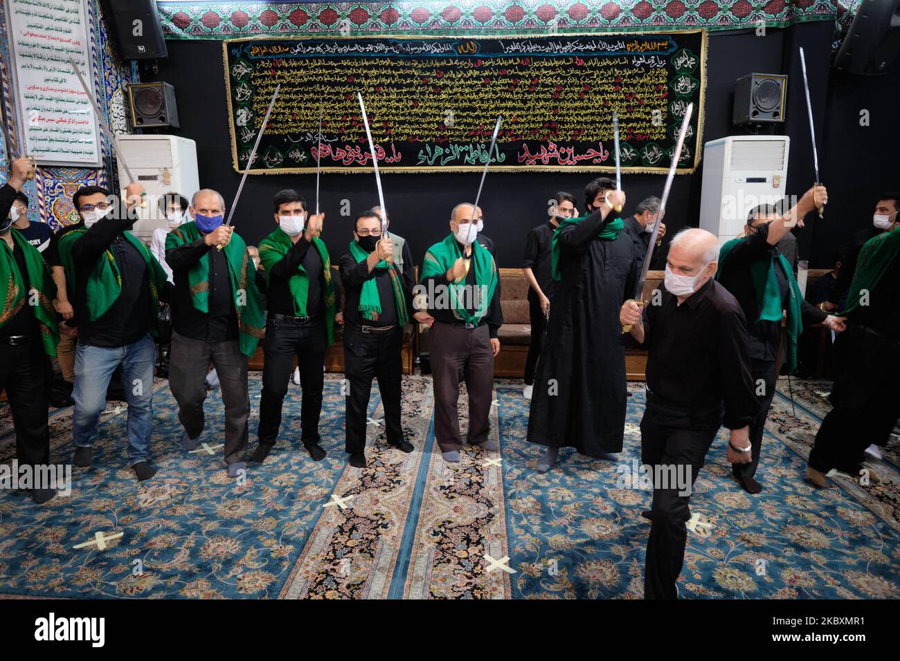 Iraqi immigration men living in Tehran wearing protective face masks ...