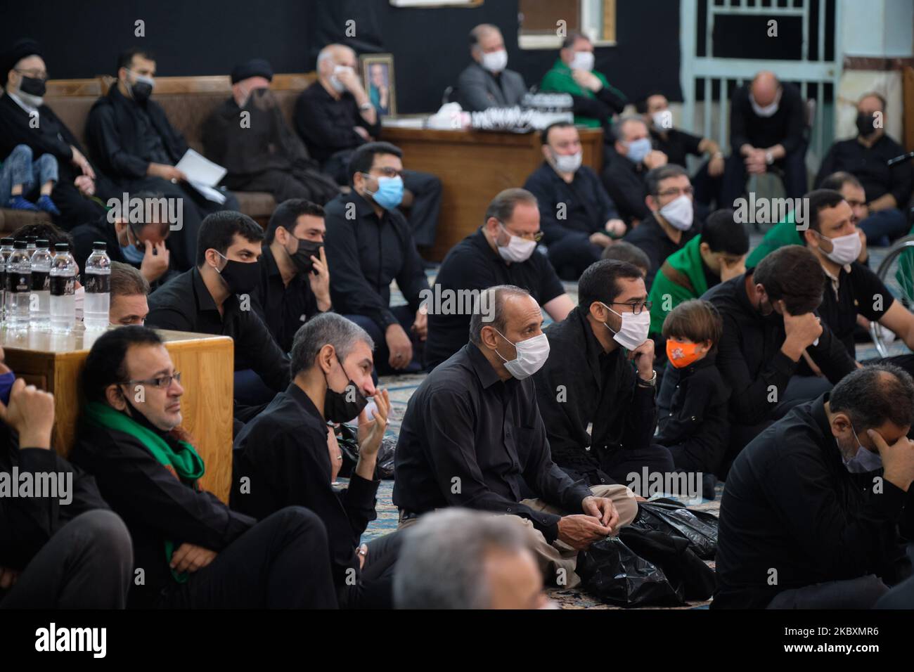 Iraqi immigration men living in Tehran wearing protective face masks ...