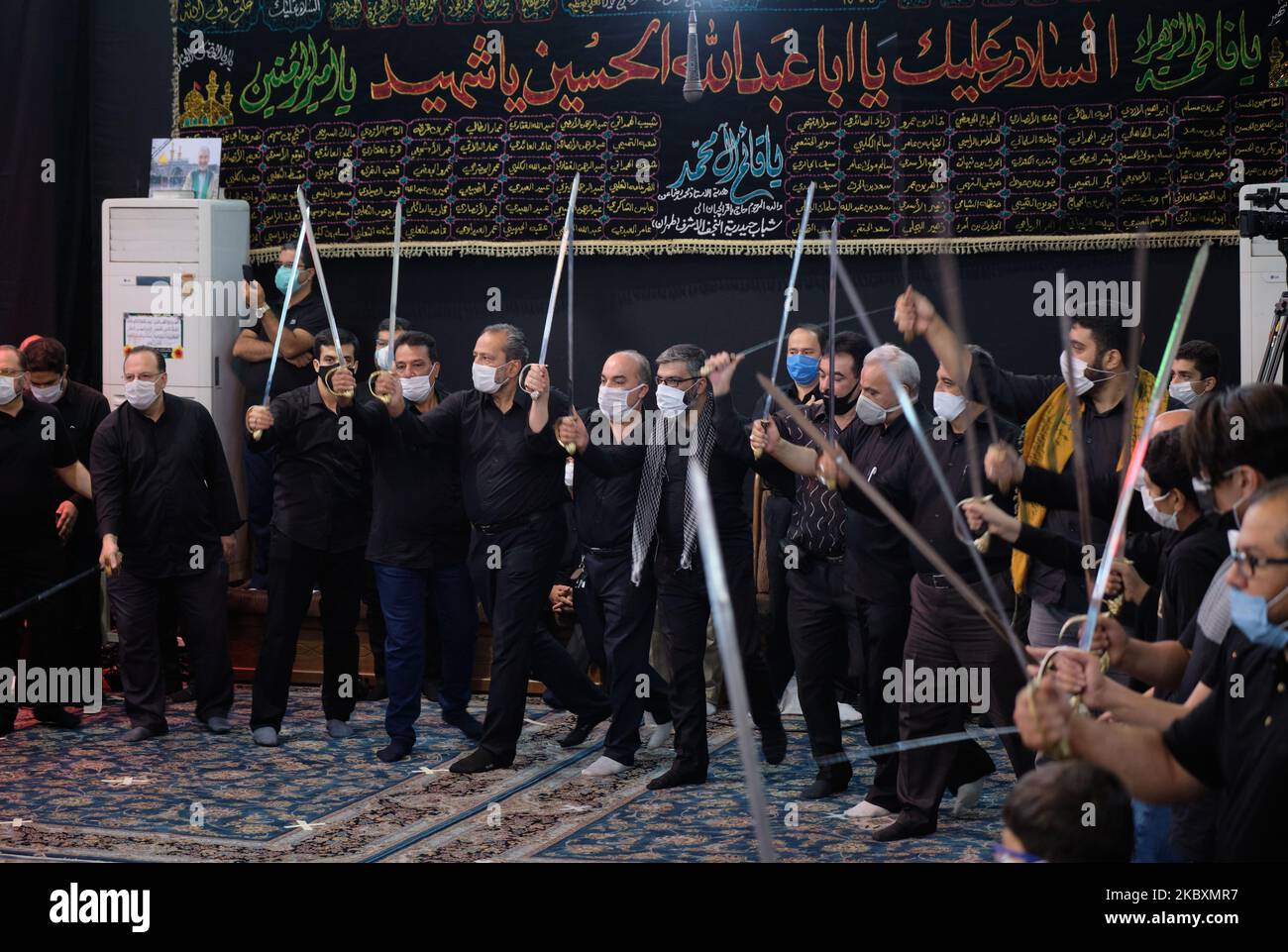 Iraqi immigration men living in Tehran wearing protective face masks ...