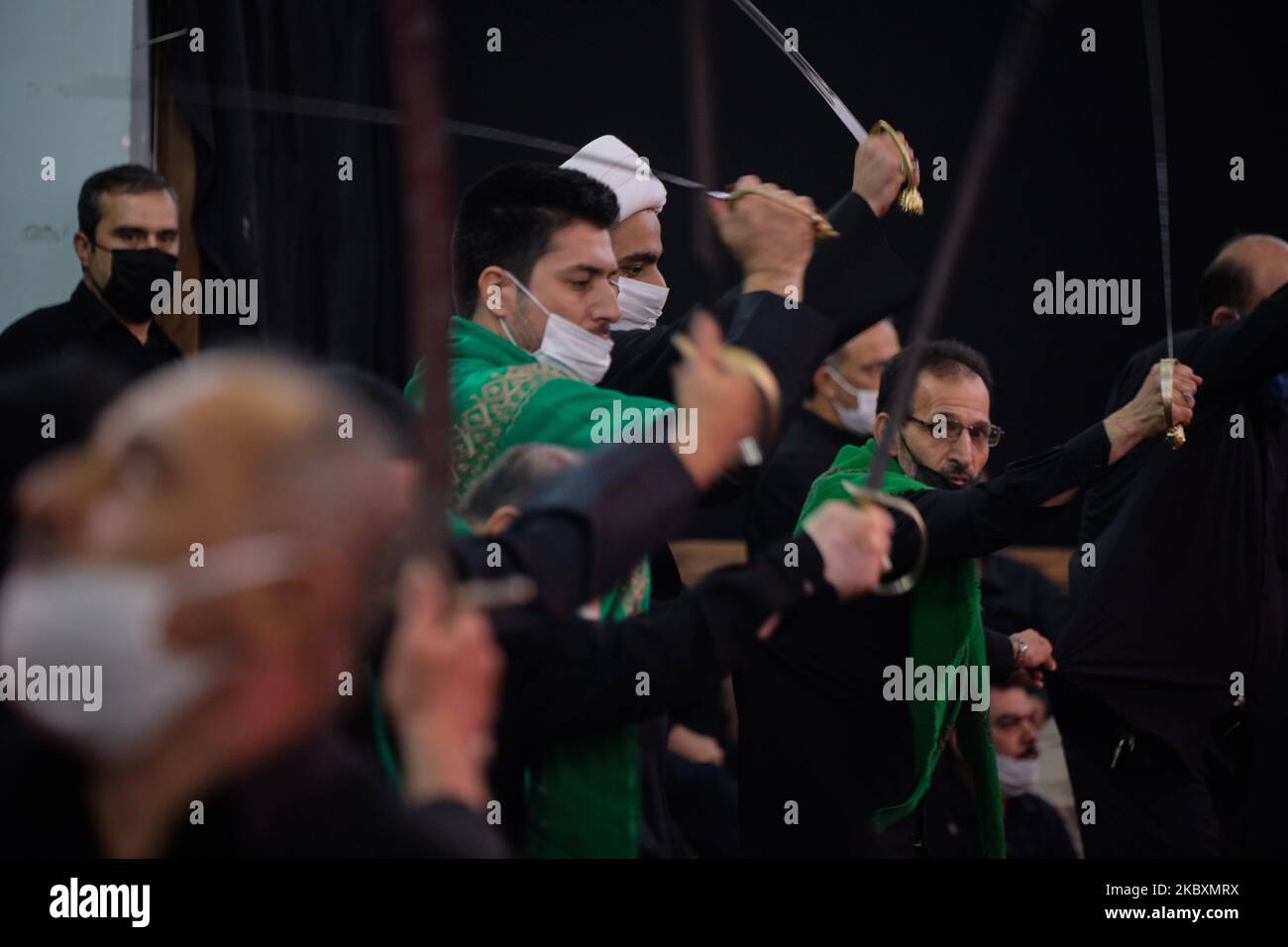 Iraqi immigration men living in Tehran wearing protective face masks ...