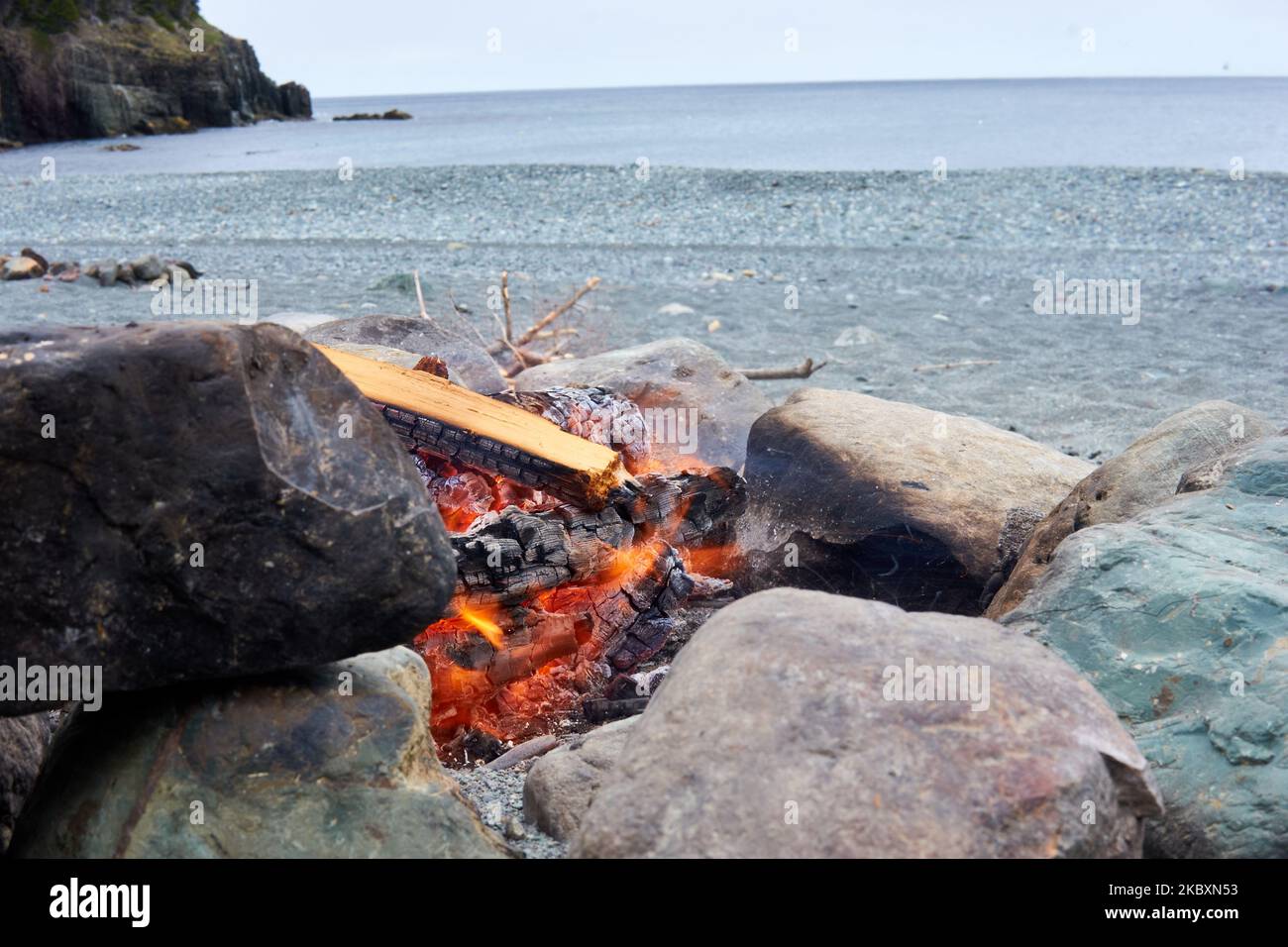 A campfire on a beach with a sea view Stock Photo - Alamy