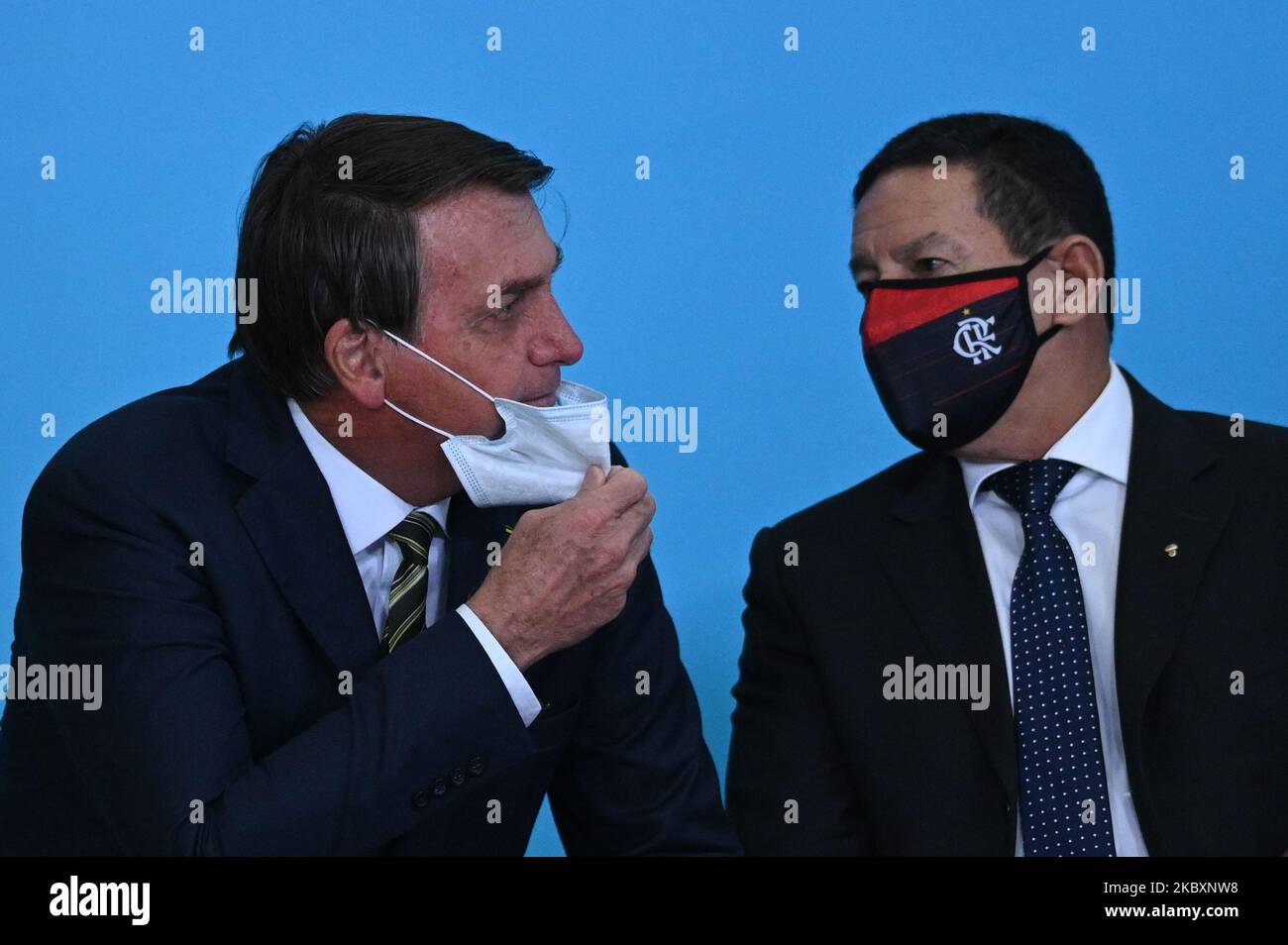 Jair Bolsonaro, Brazil's President removes his face mask to speak with ...