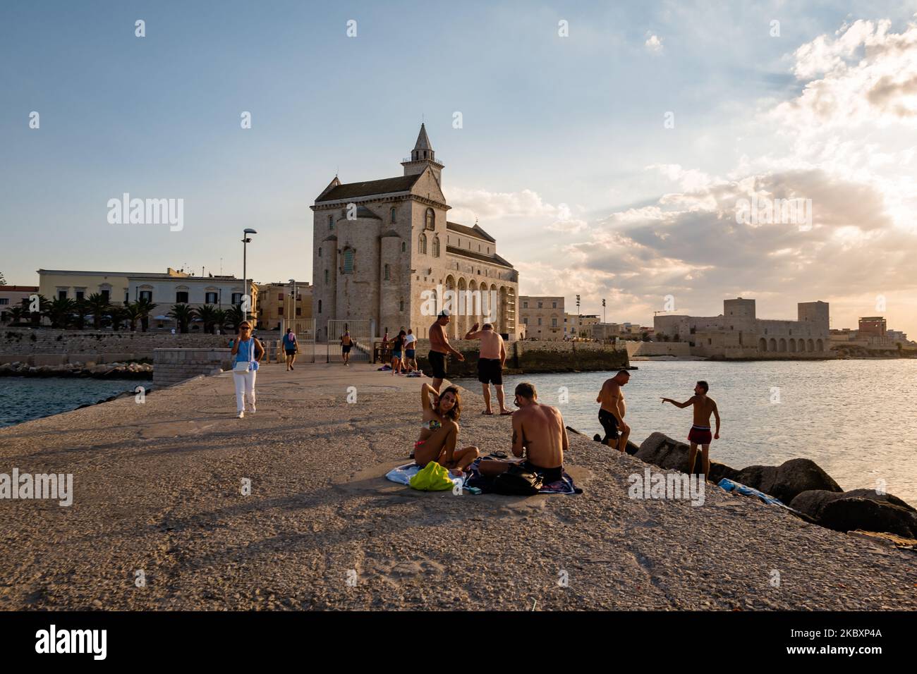 People enjoying the sea on a public beach in front of the Cathedral of ...