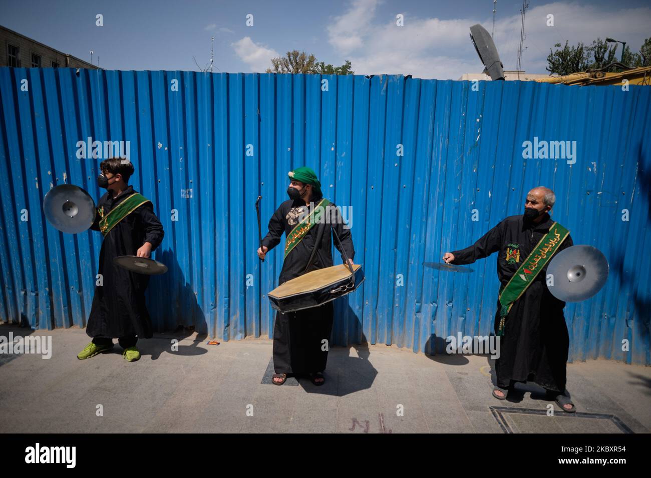 Iraqi men living in Tehran wearing protective face masks play musical ...