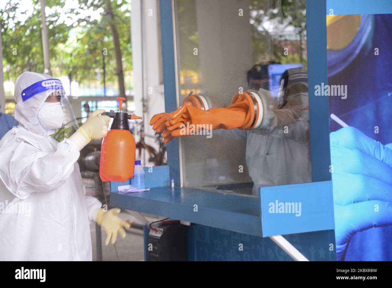 Health worker sprays disinfectant after a lab technician collected a ...