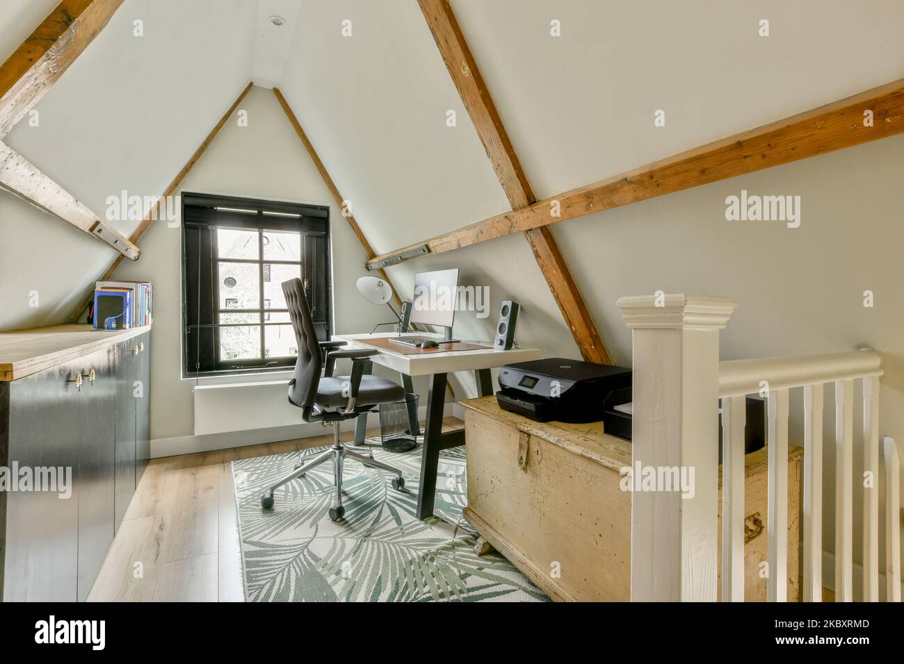 Comfortable chair placed near desk with computer monitors and ...