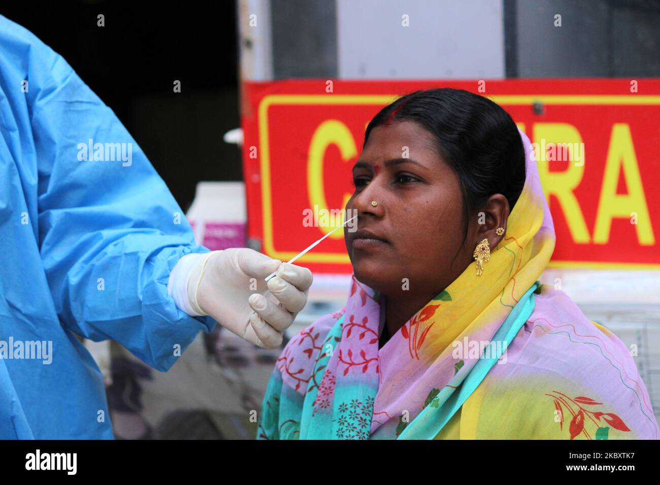 A health worker collects a nasal swab sample from a patient for Covid ...
