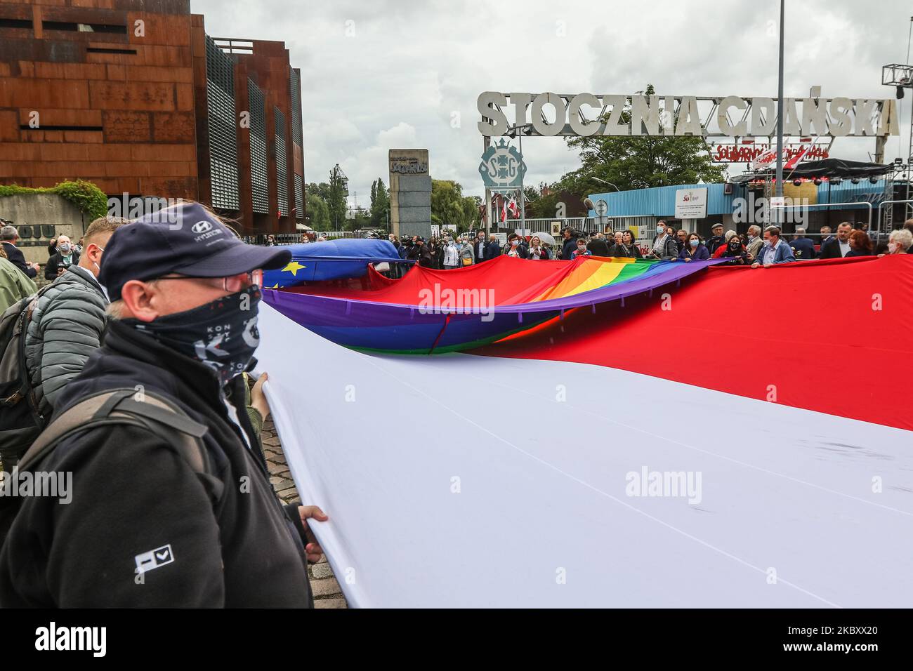 Peopleholding giant Polish EU and rainbow (LGBT) flags are seen in ...