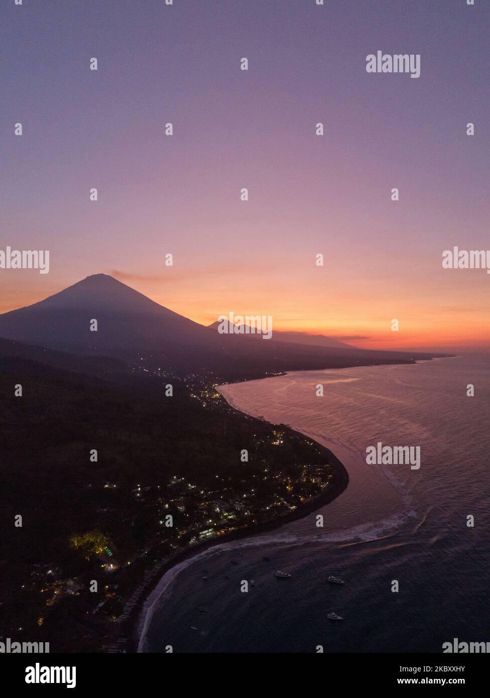 An aerial view of Bali with silhouettes of mountains at sunset ...