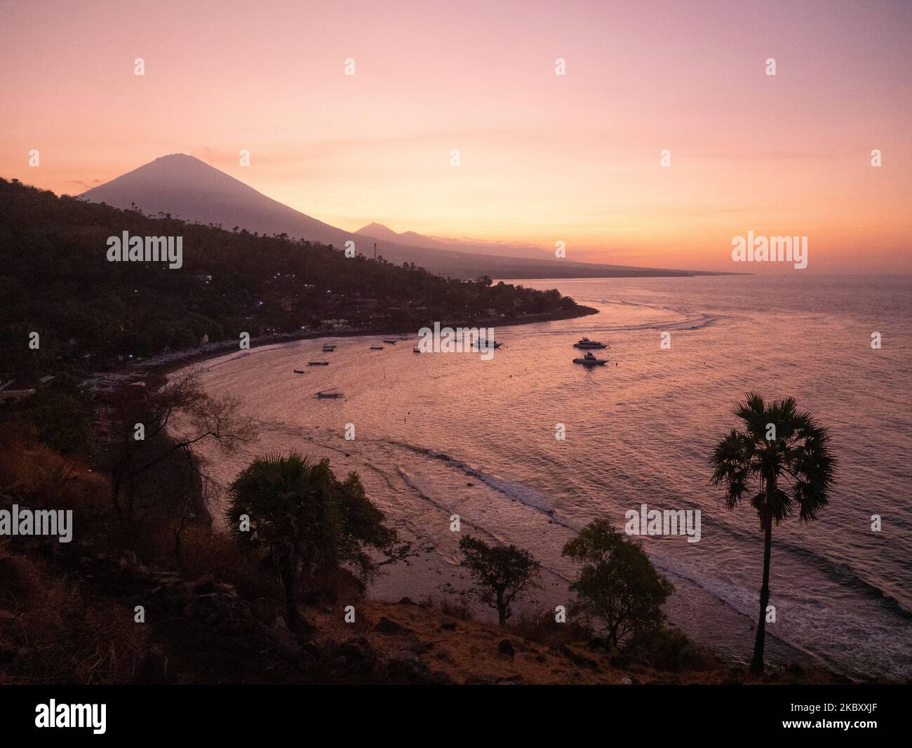 An aerial view of Bali with silhouettes of mountains at sunset ...