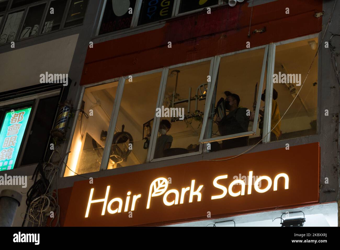 A hair salon employees shine mirors on riot police on Sai Yeung Choi ...
