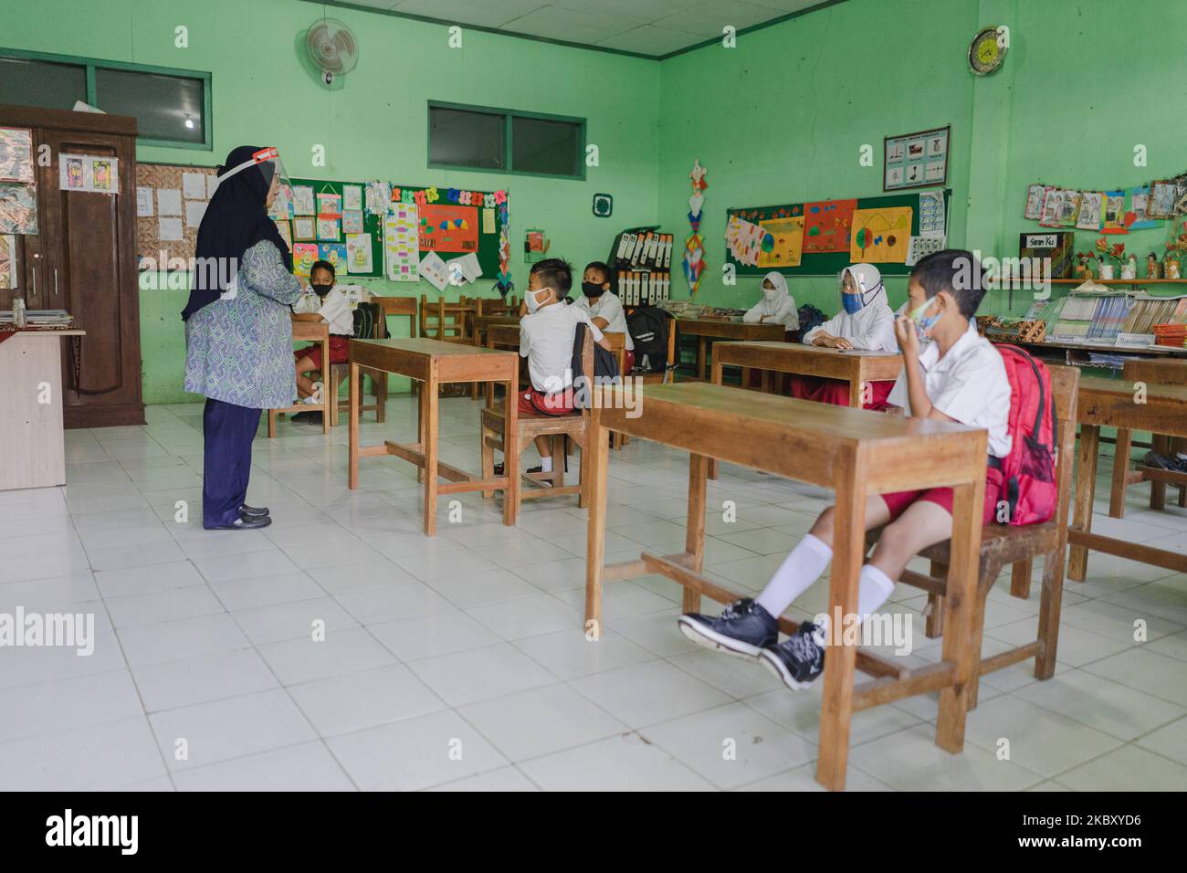 A teacher teach the students in a classroom at Candirejo Elementary ...