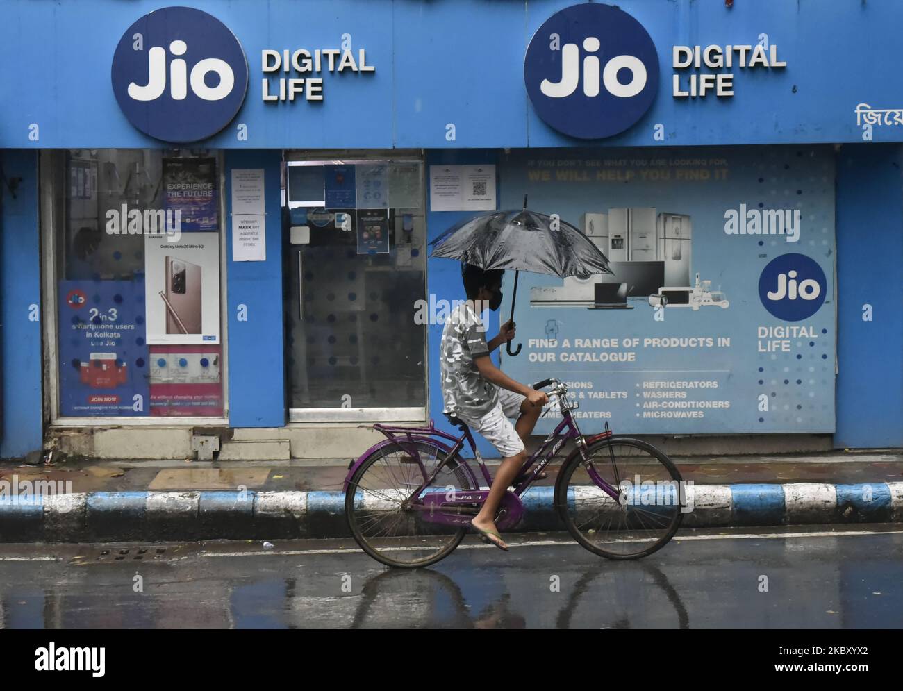 A man passes by a Jio Digital store in Kolkata, India, on September 01 ...