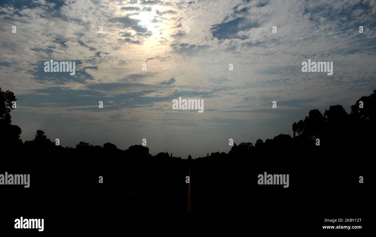 A cloudy sky with a view down Rajpath during a hot and humid evening on ...