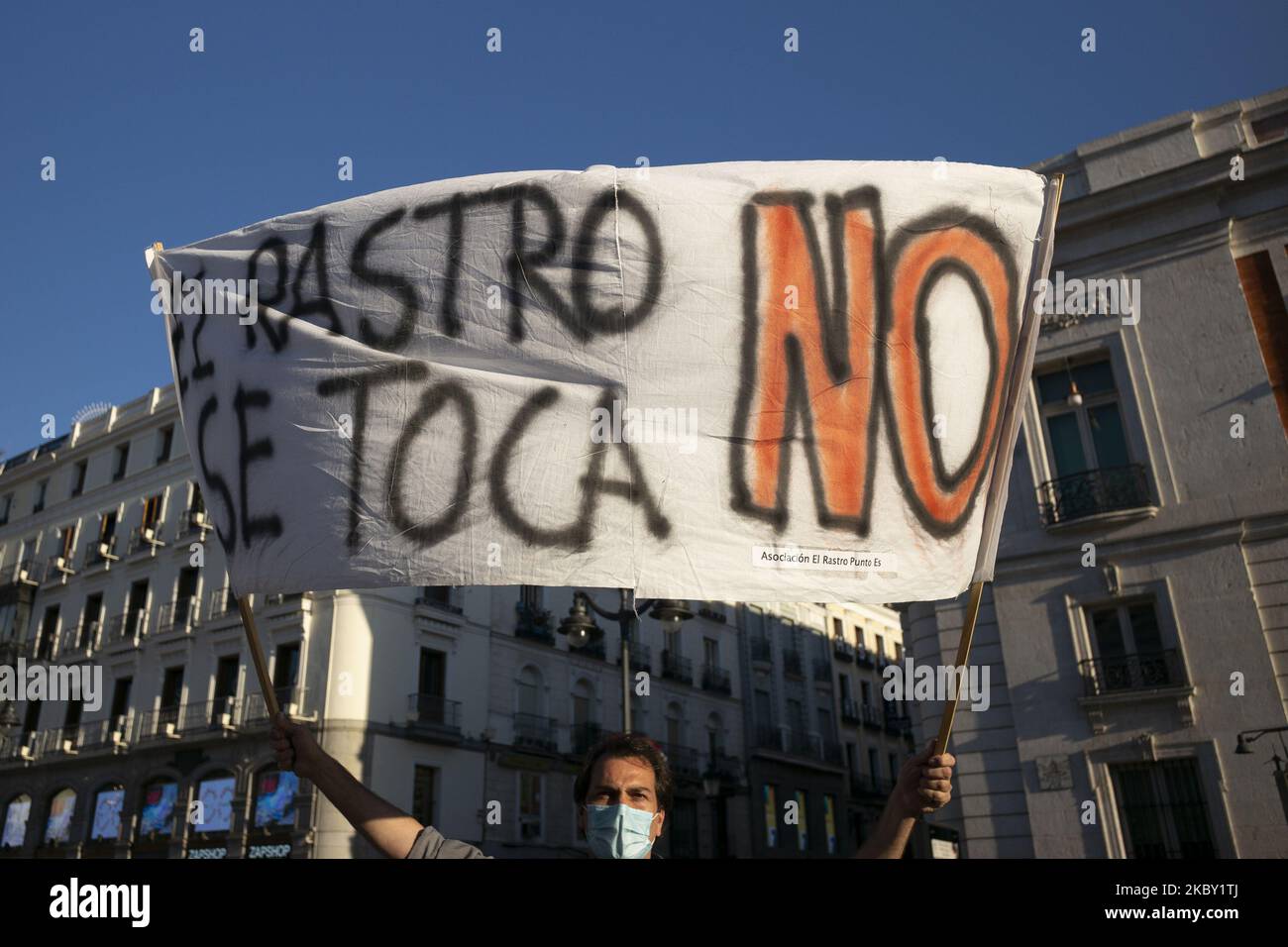 Traders from El Rastro in Madrid hold banners during the demonstration ...