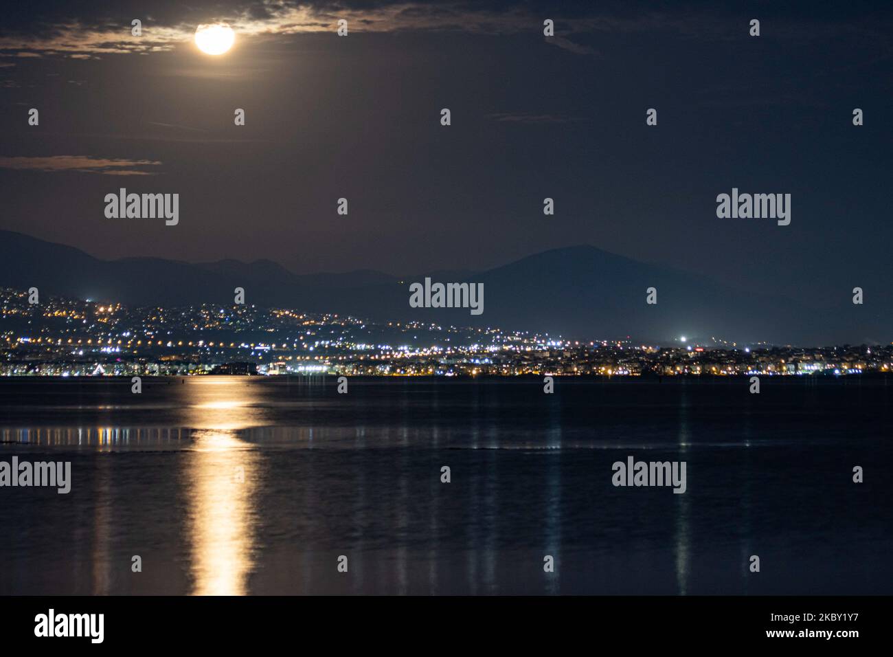 The Full Corn Moon as seen behind Hortiatis mountain over the city of ...
